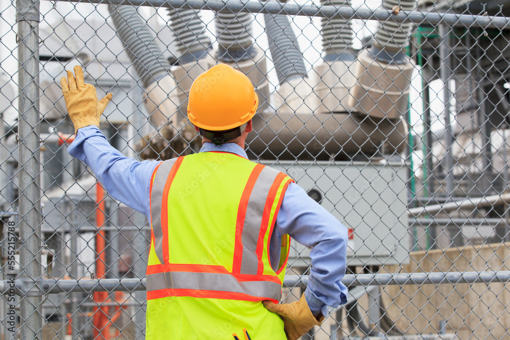 Electrical engineer examining transformers inside of an electric power ...
