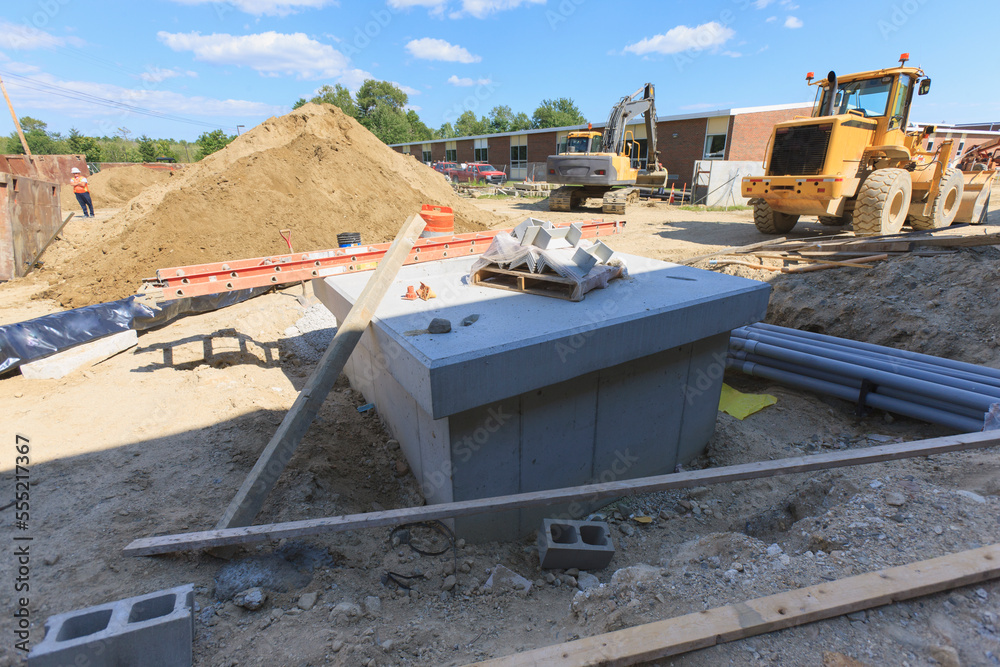 Electrical system transformer vault at construction site with front end ...