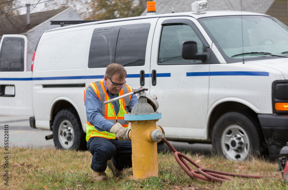 Water department technician reinstalling caps on fire hydrant Stock ...