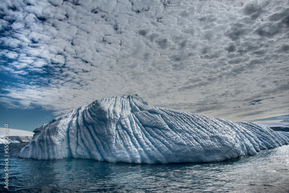 High clouds over an iceberg off Antarctica's Enterprise Island ...