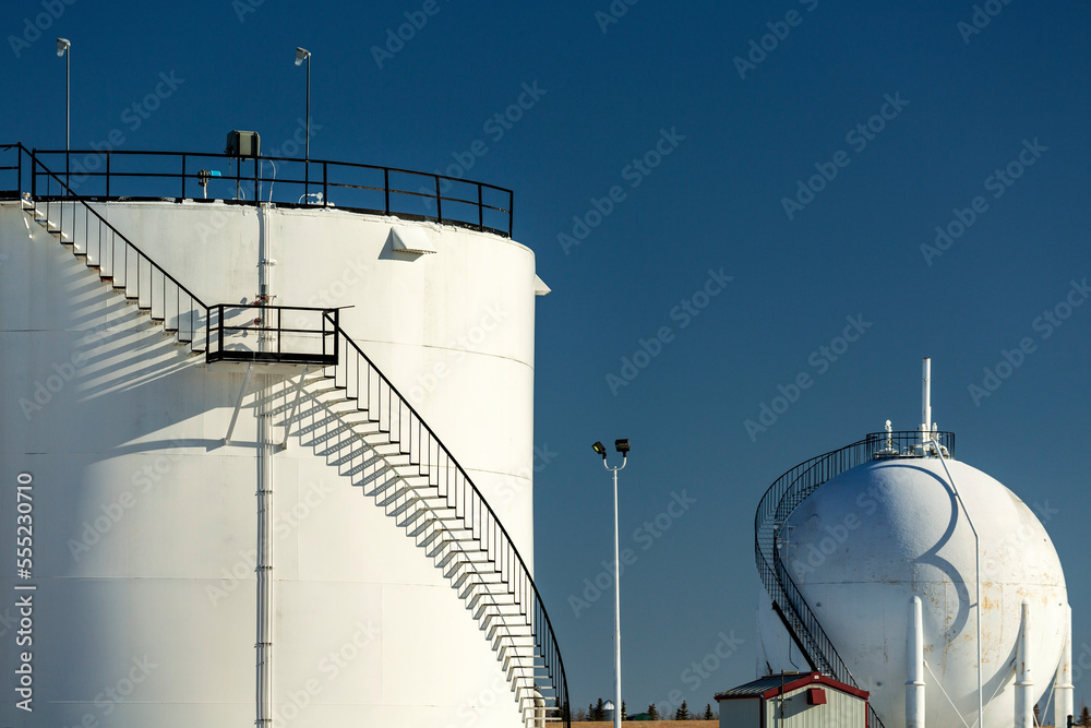 Large white spherical and round oil storage tanks with black metal ...