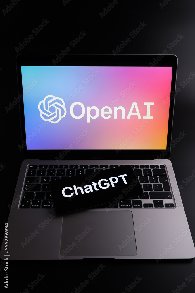 ChatGPT logo seen on smartphone and laptop display with blurred OpenAI ...