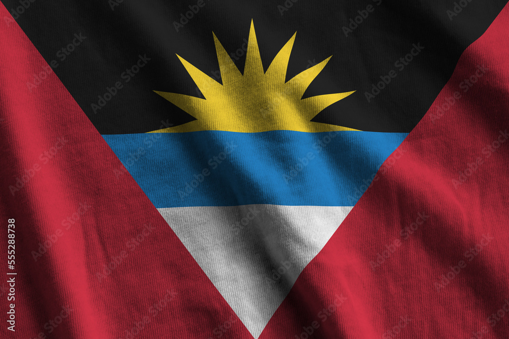 Antigua and Barbuda flag with big folds waving close up under the ...