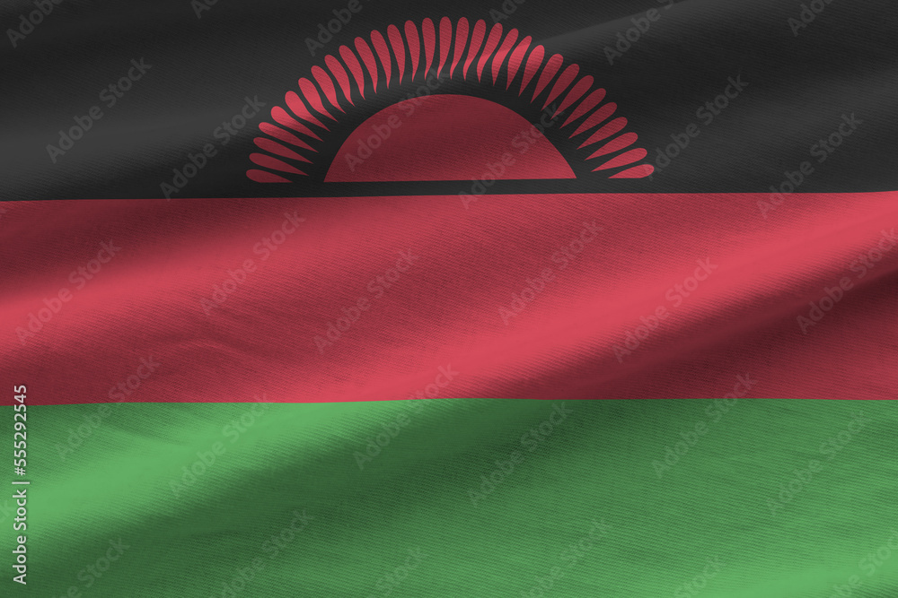 Malawi flag with big folds waving close up under the studio light indoors. The official symbols ...