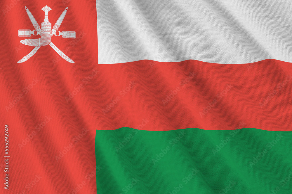 Oman flag with big folds waving close up under the studio light indoors ...