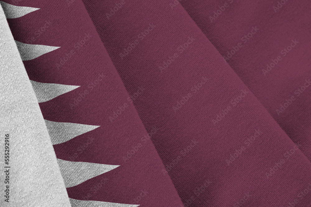 Qatar flag with big folds waving close up under the studio light ...
