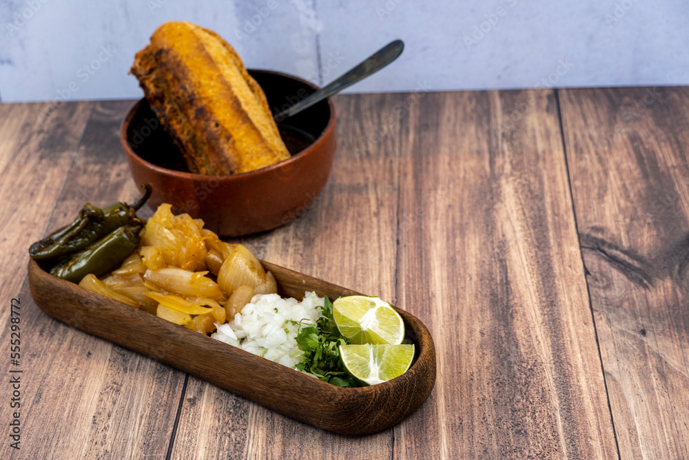 torta ahogada consome y birria, dish with onion, sweet onion and chile ...