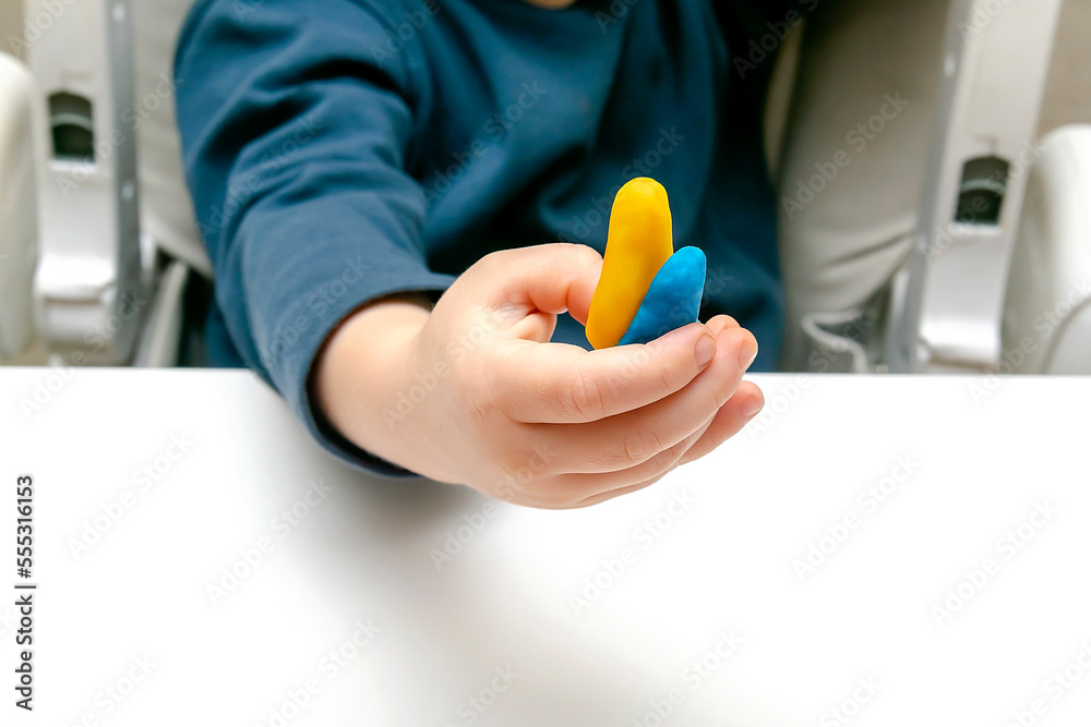 child molding plasticine.Kid sculpts with clay stucco.Play dough ...