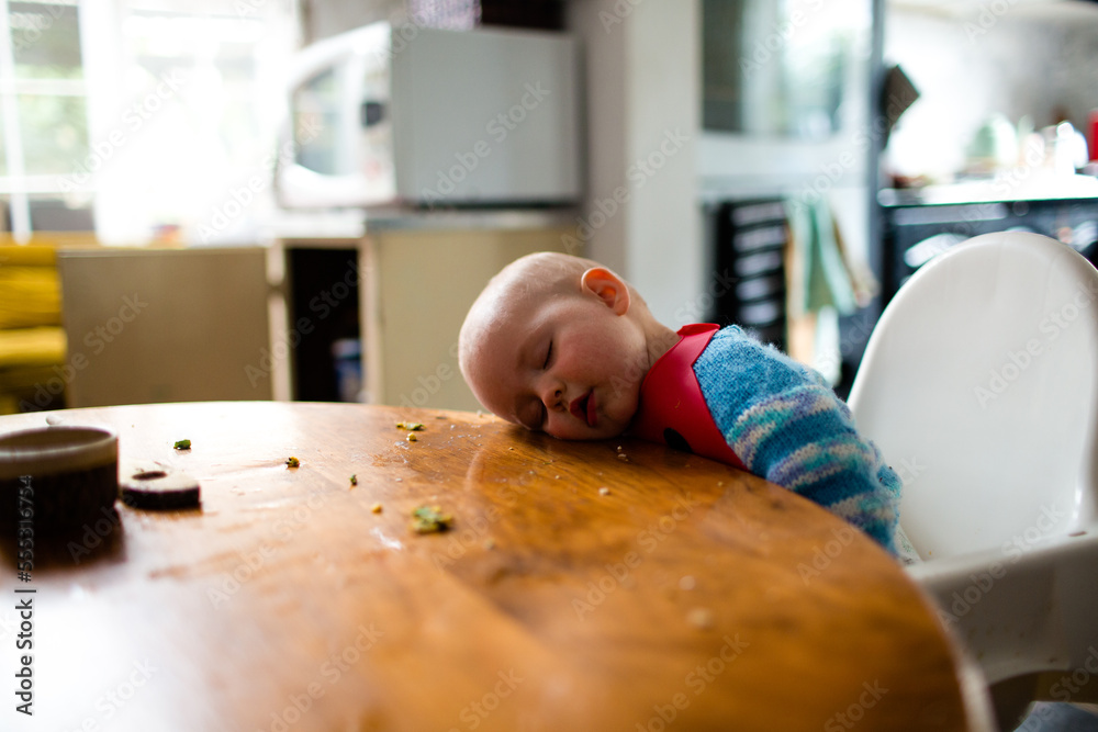 Baby asleep at the kitchen table Stock Photo | Adobe Stock