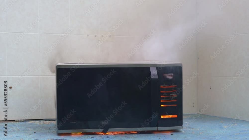 microwave oven on fire. the concept of fire in the kitchen and ...