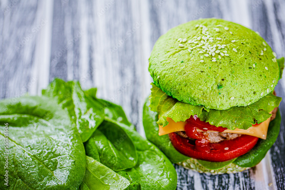From above view of green homemade burger with marble beef with veggies ...