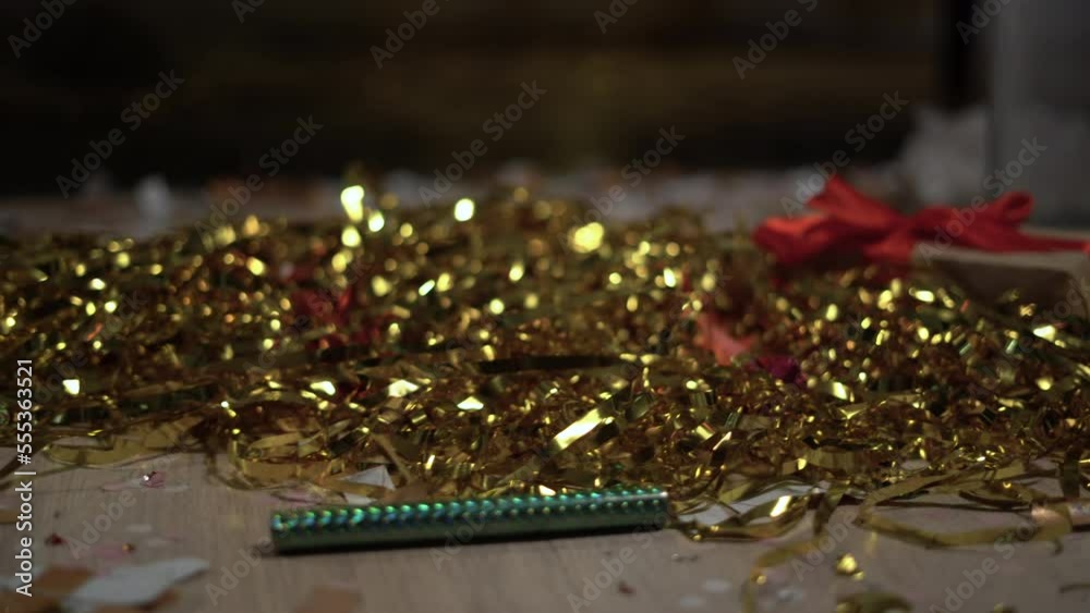 Floor with after a party celebration with empty bottles, gift box and ...