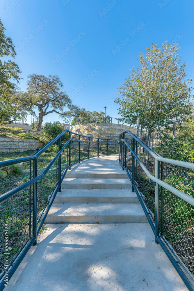 Paved pathway with steps and rails for visitors of Waterloo park in ...
