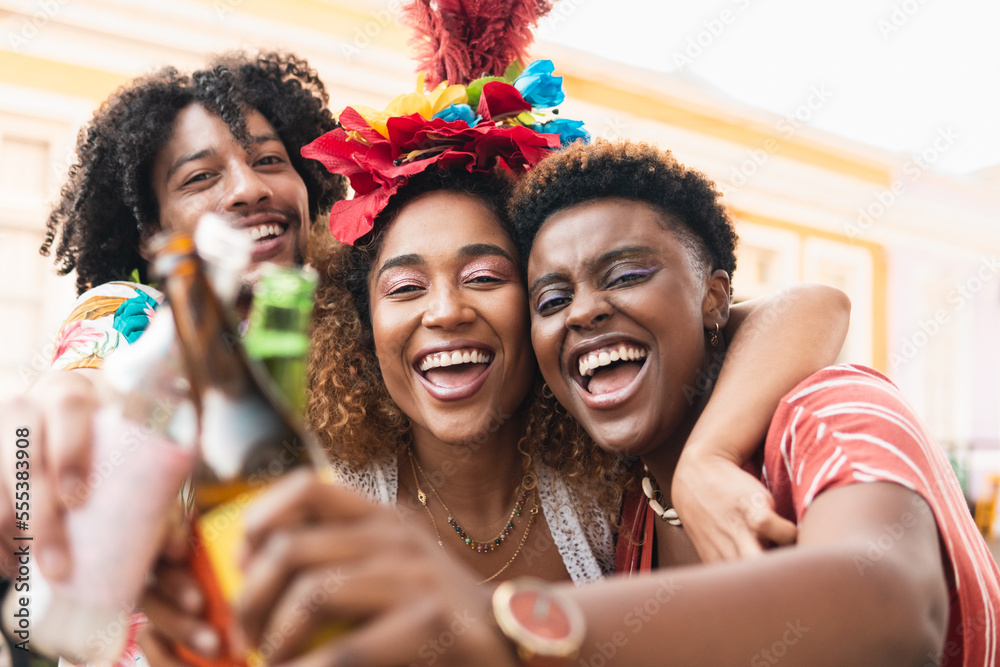 Friends celebrating Carnival in the street. Brazilian people toasting ...