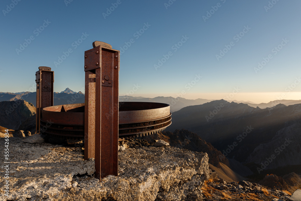The rusty wheel of an ancient military ropeway. These ruins are part of ...
