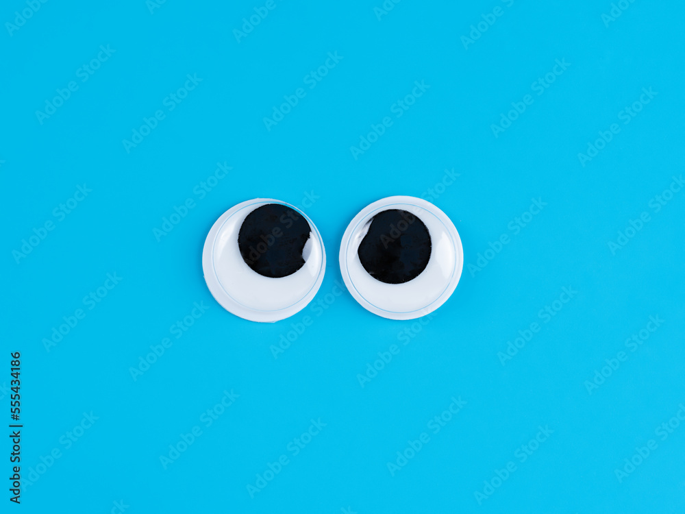 funny googly eyes cute Isolated on bright light blue background copy ...
