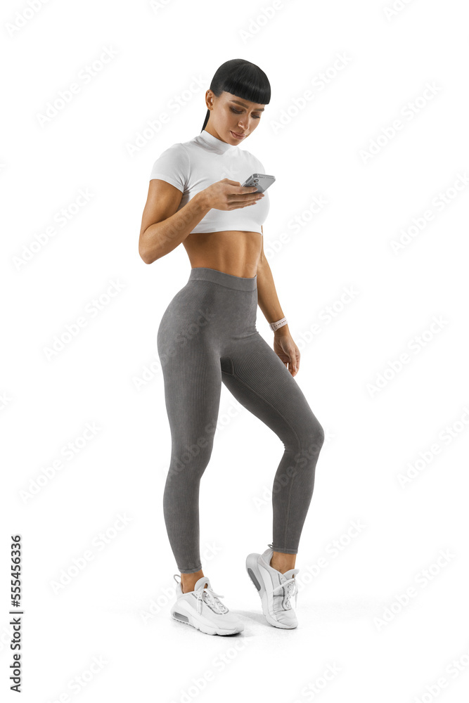 Active fitness girl using smartphone. Female coach uses a smartphone to ...