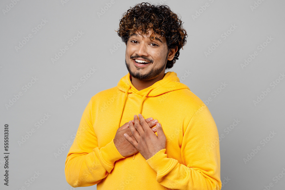 Young kind-hearted fun smiling Indian man 20s wear casual yellow hoody ...