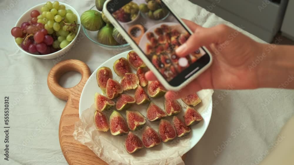 fresh cut figs close up. View of cutting fig fruit with knife. the girl ...