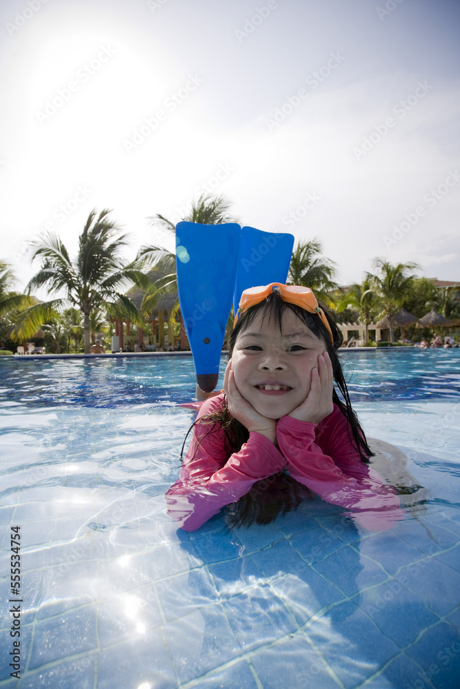 Portrait of Girl Lying in Swimming Pool Wearing Goggles and Flippers ...