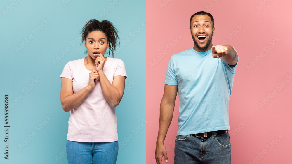 Shocked black couple gaze straightly at camera, happy man pointing at ...
