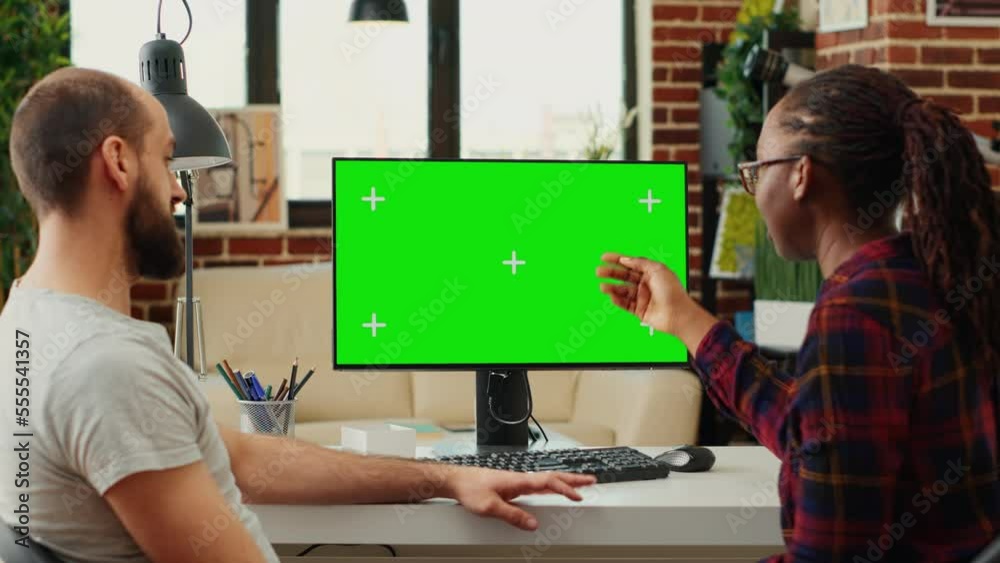 Diverse people working with greenscreen monitor on computer, analyzing ...