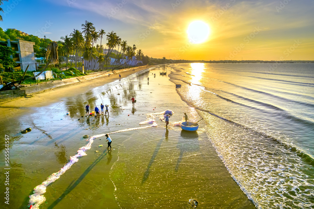 Dawn on the beach with tilted coconut trees, long sandy beach and ...