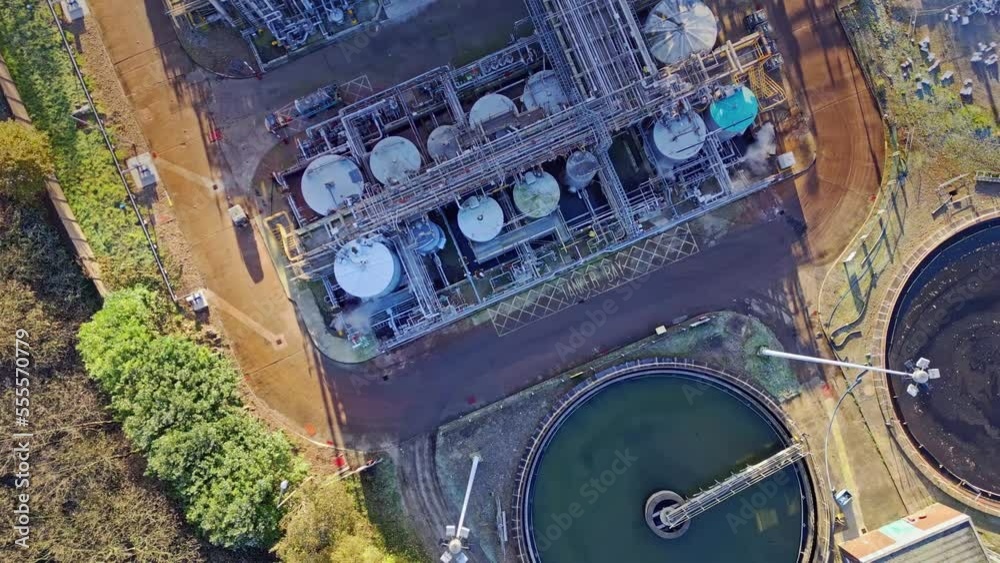 Overhead aerial footage moving towards a large industrial chemical ...