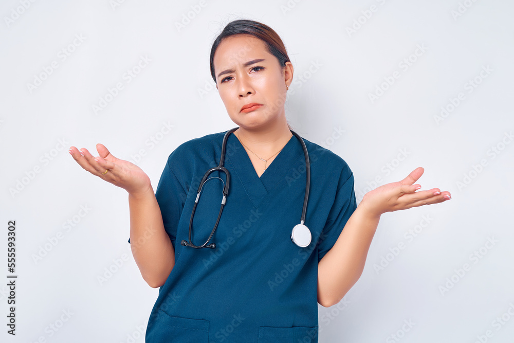 Clueless young Asian woman nurse wearing blue uniform with a ...