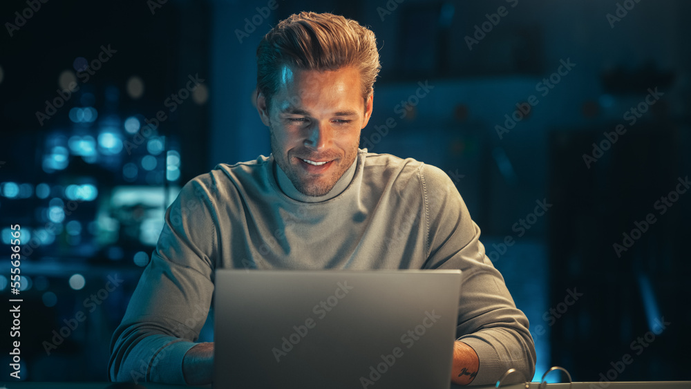 Handsome Man Working on Laptop Computer in a Company Office at Night ...