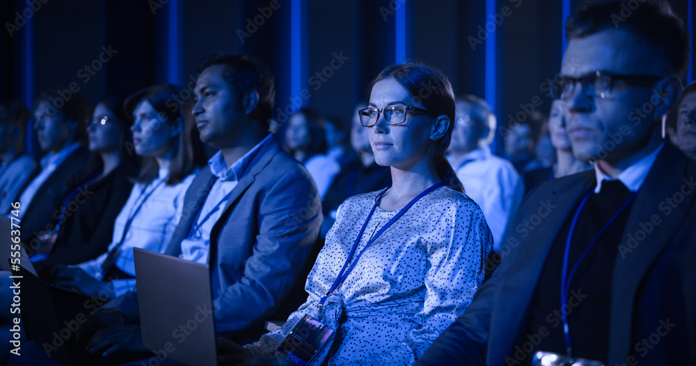 Male Sitting in a Dark Crowded Auditorium at a Tech Conference ...