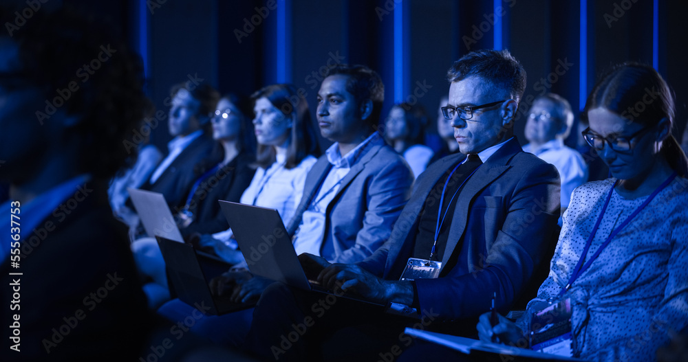 Young Man Sitting in a Crowded Audience at an IT Conference. Delegate ...