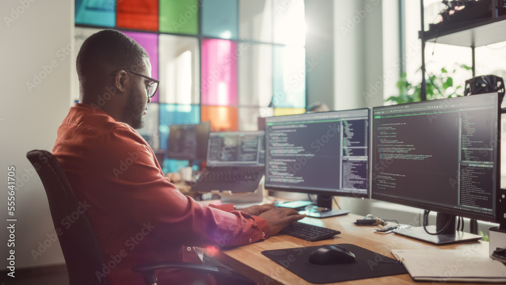 African American Man Coding on Desktop Computer with Professional ...