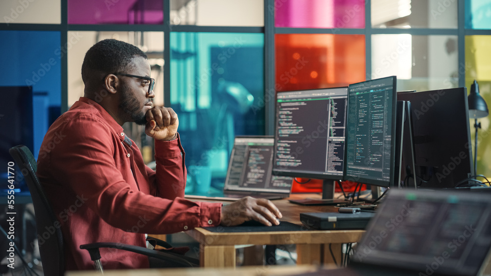 Male Senior Software Developer Writing Code On Desktop Computer With ...