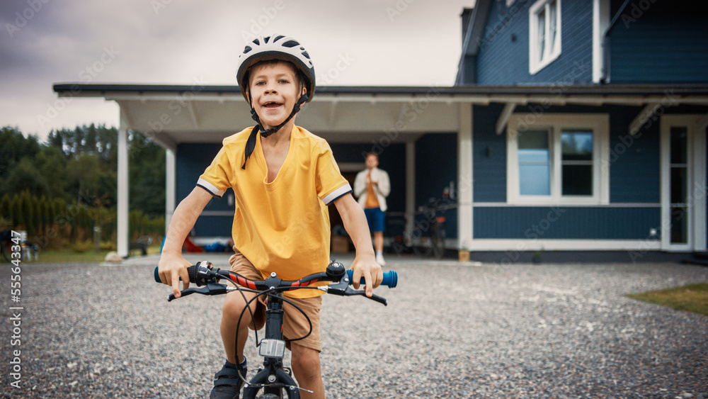 Cheerful Father Teaching His Son to Ride a Bicycle in The Front Yard of ...