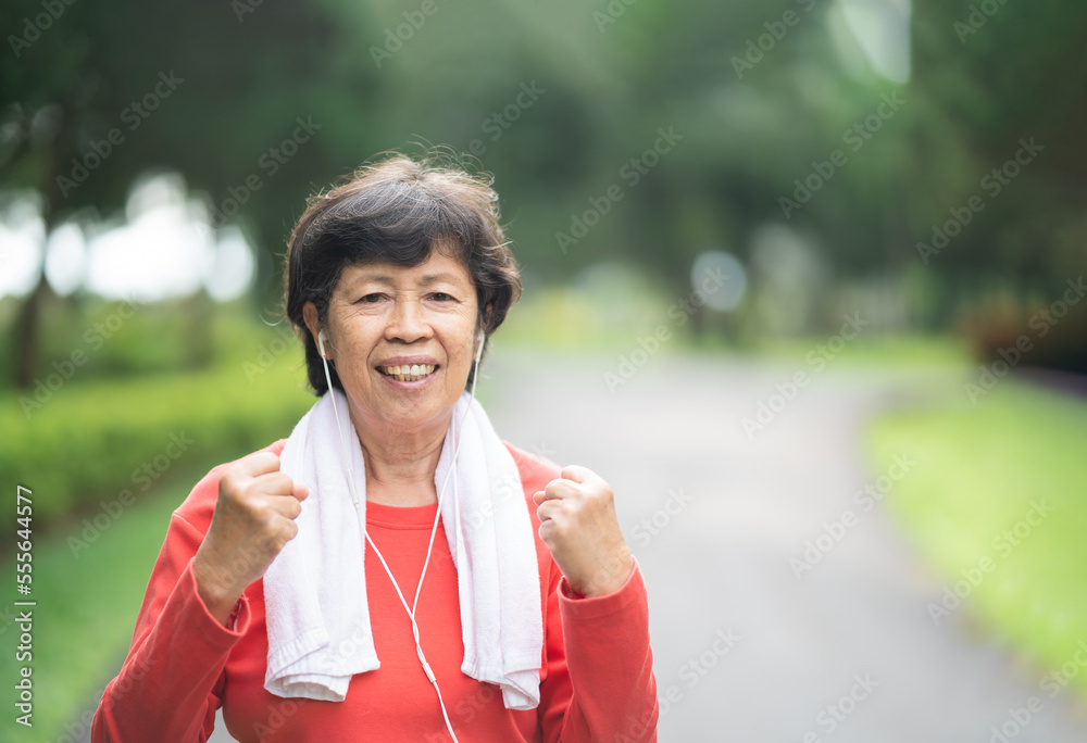 Athletic asian senior woman 60s smiling, hands up and happy cheerful ...