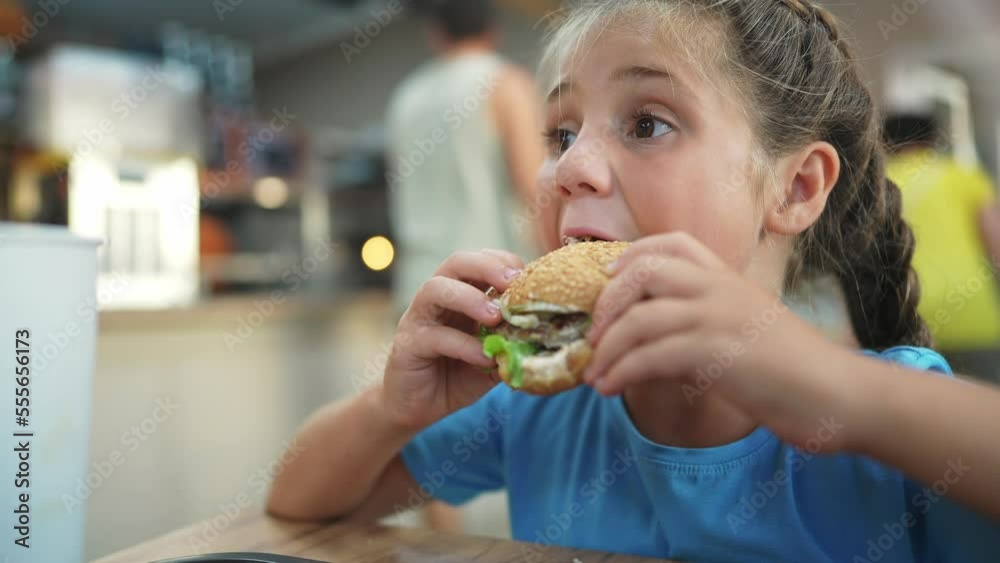child kid eating lifestyle a burger in a cafe. fast food nutrition ...