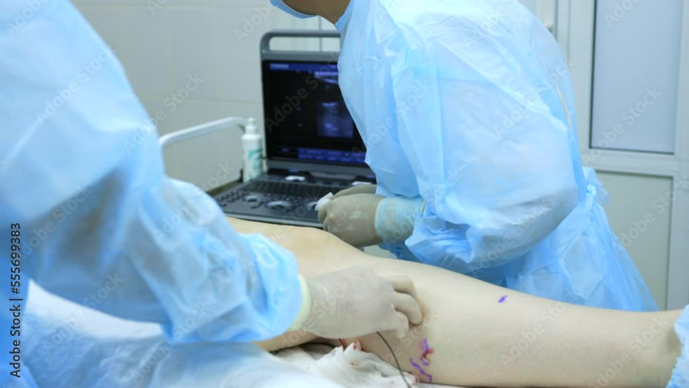 Assistant shows the affected areas on the ultrasound monitor screen of ...