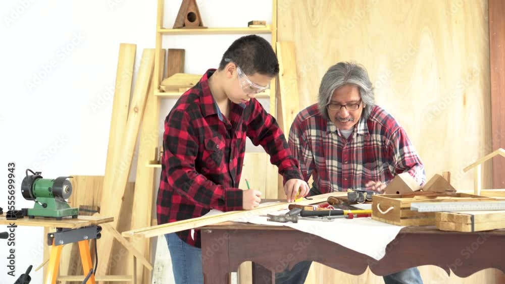 Asian pre-teen boy help grandfather work woodwork, teenager boy taking ...