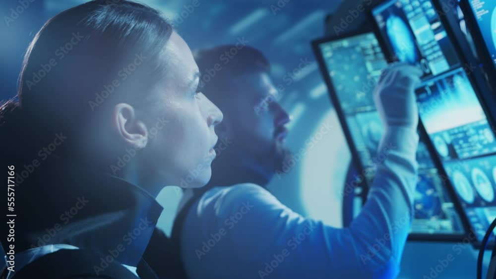 Team of astronauts in a space suits aboard the orbital station. A crew ...