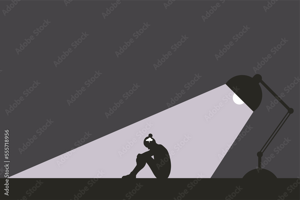 Sad and depressed woman sitting alone under the spotlight. Depressive disorder. Mental health ...