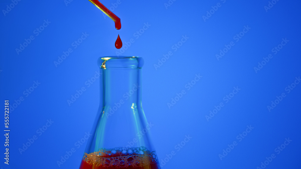 A drop of blood. Pipette. On a blue background. Medical flask with red ...