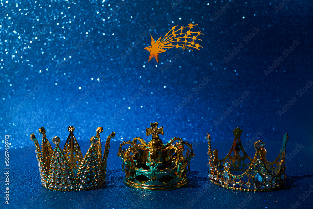 Three crowns of the three wise men with star over blue background. For ...