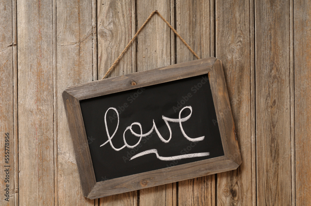 Love Written in Cursive on Chalkboard and Hanging on Wooden Wall Stock ...