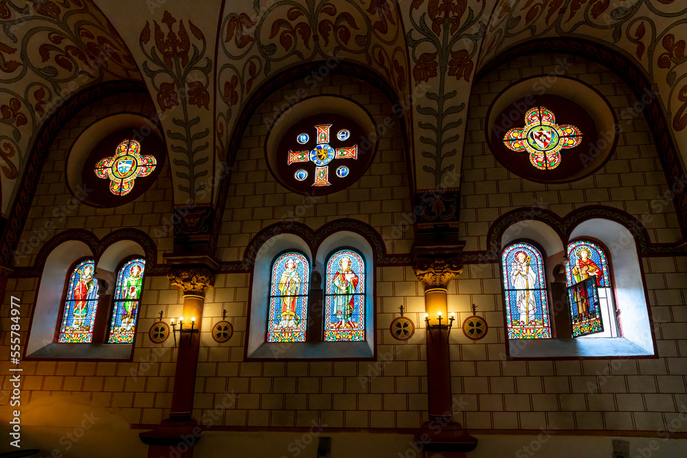 Colorful stained glass windows inside the Chapelle Saint-Leon IX, a ...
