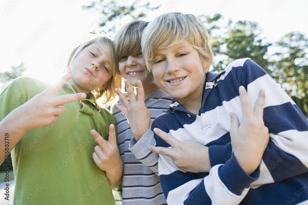 Boys Making Hand Gestures Stock Photo | Adobe Stock