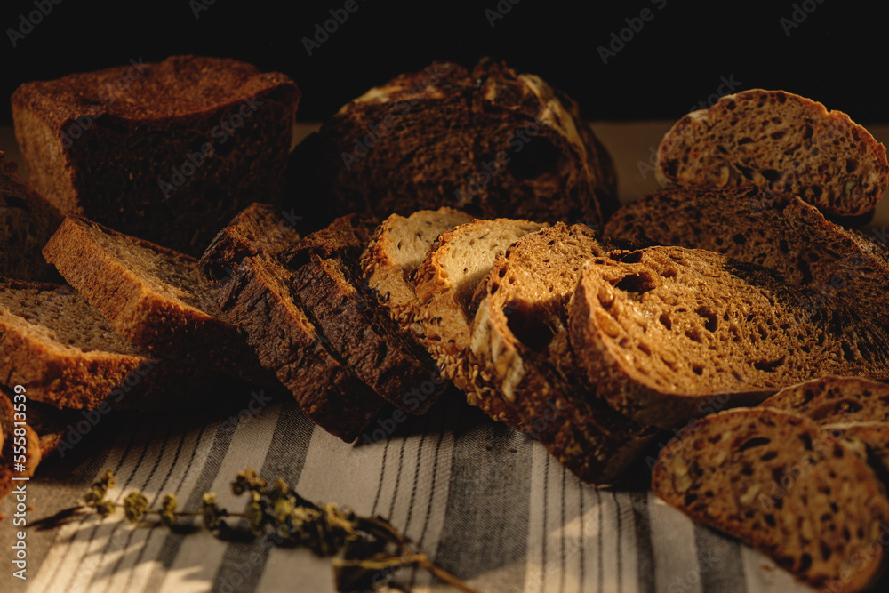 Bread, traditional sourdough bread, cut into slices on a rustic ...