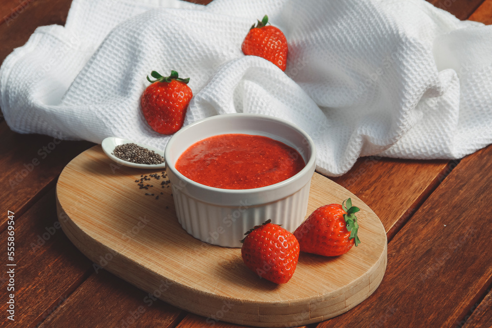 Homemade strawberry jam in a white ceramic bowl with chia seeds ...