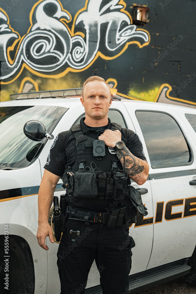 Vertical image of white male caucasian police officer posing with ...
