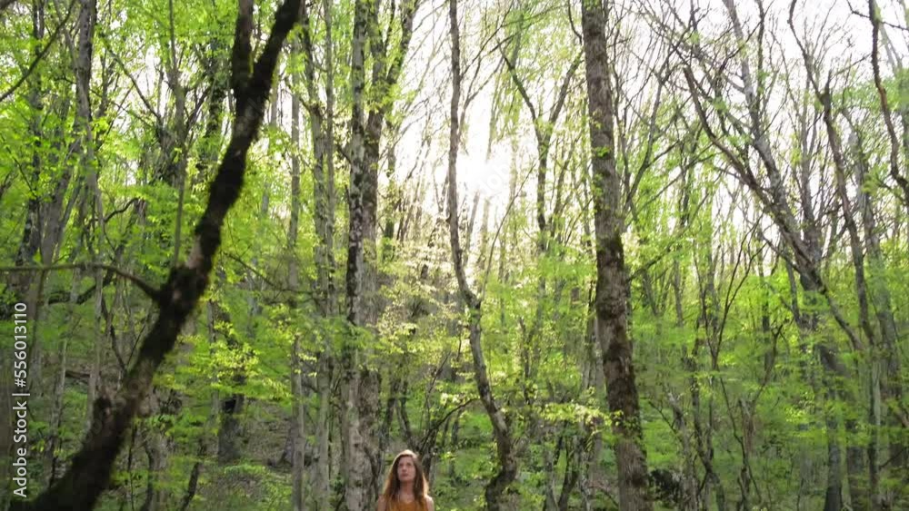 Girl walks in park connecting with nature. a girl walks through the ...